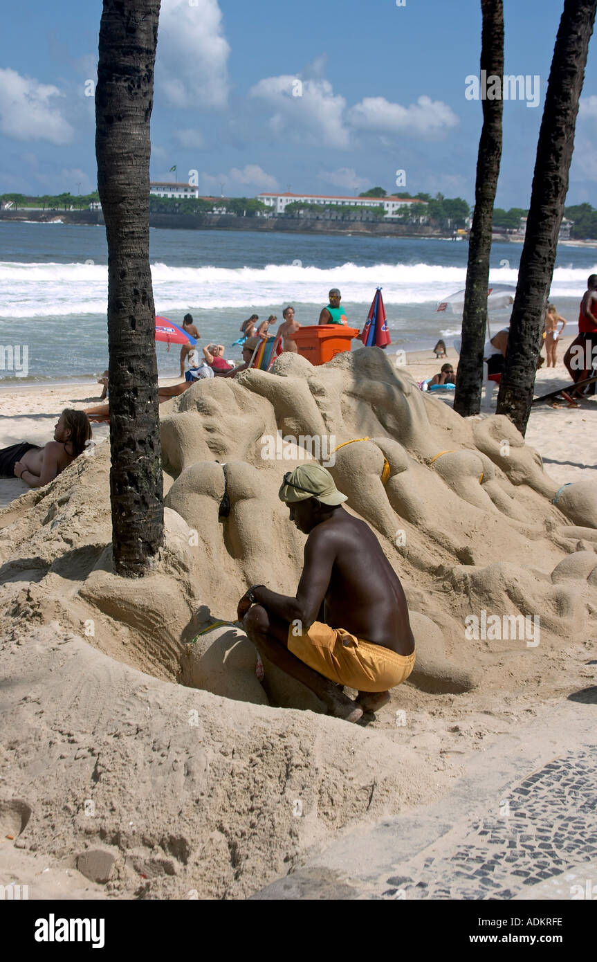 Artist With Sand Sculpture Of Women In Bikinis Sunbathing Copacabana