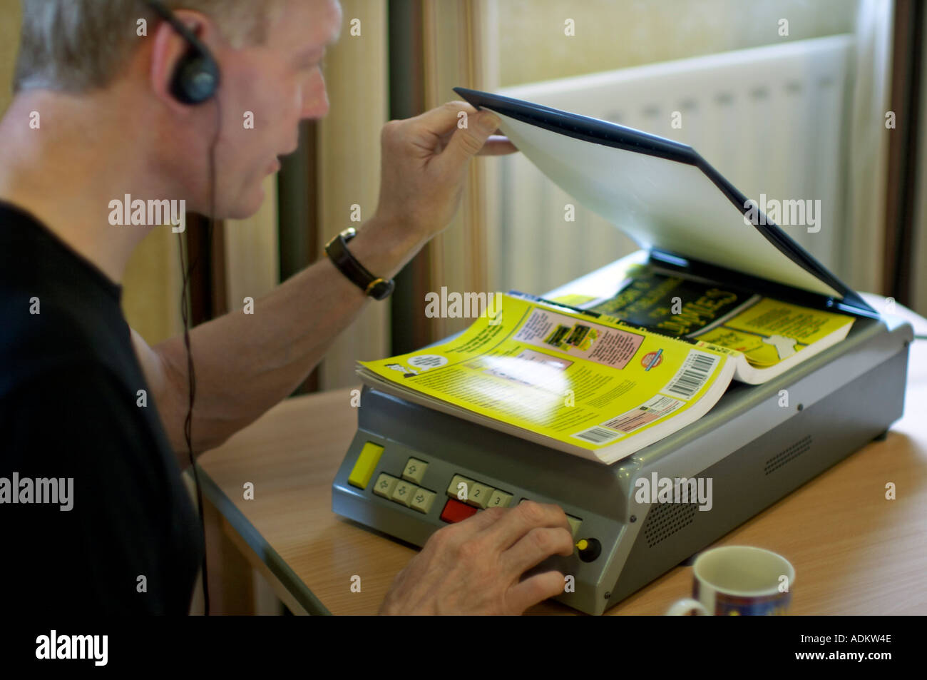 Blind man with impaired vision or sight using a reading machine Stock ...