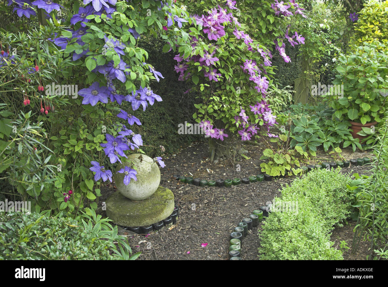 Summer garden pathway with bottle lined path Stock Photo - Alamy