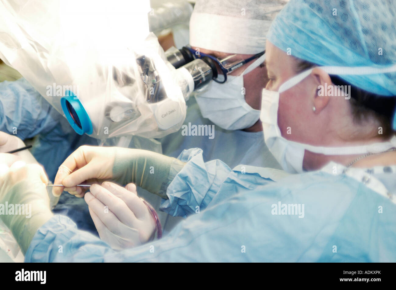 A surgical team use micro techniques to operate on a patients inner ear ...