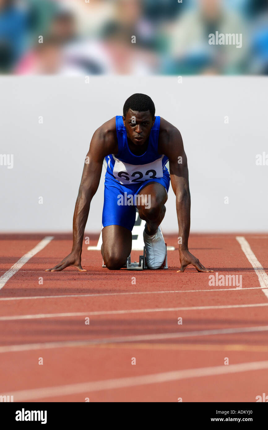 Male Runner Crouched On Starting Blocks Stock Photo - Alamy