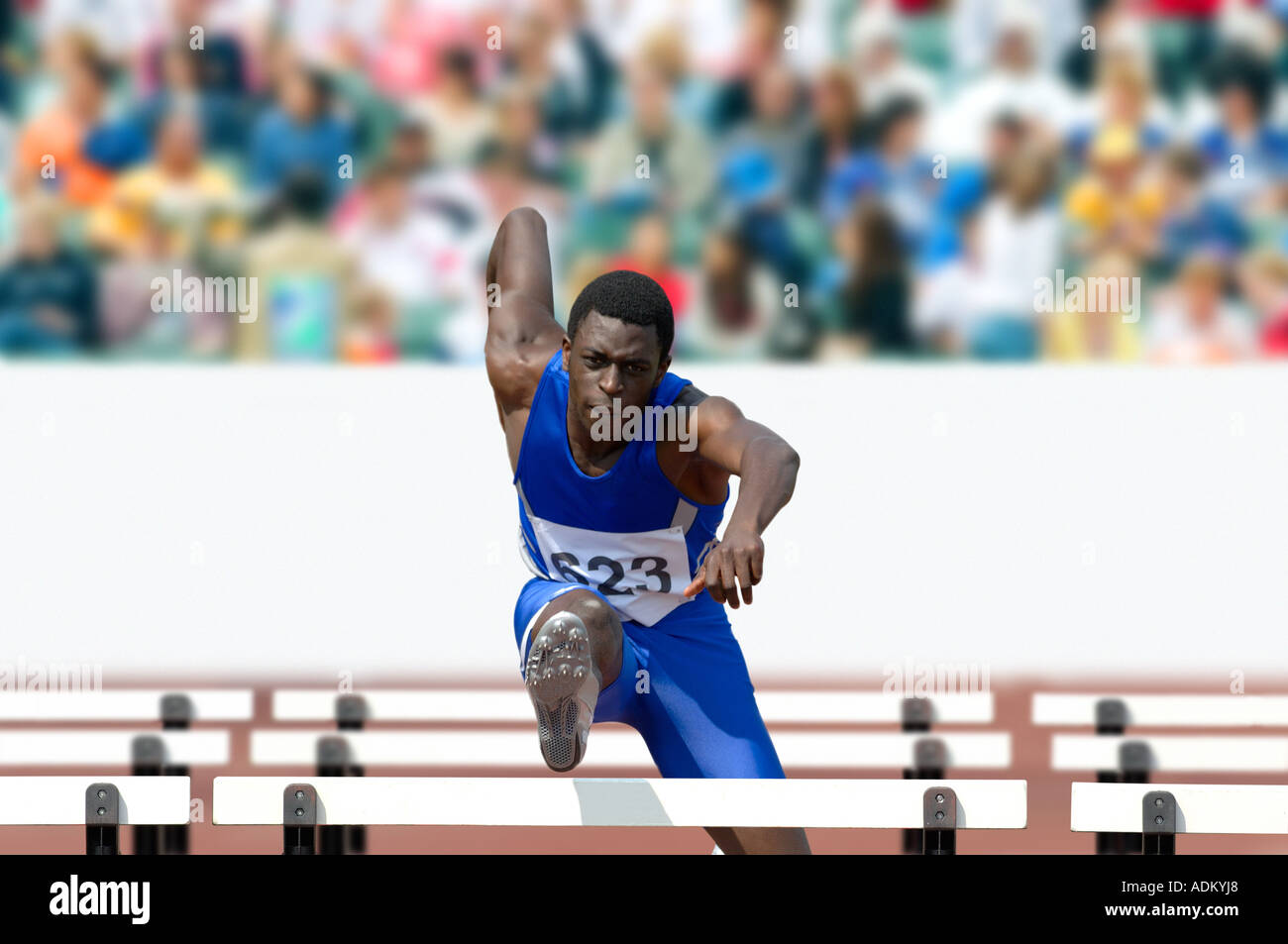 Male Runner Clearing a Hurdle Stock Photo - Alamy