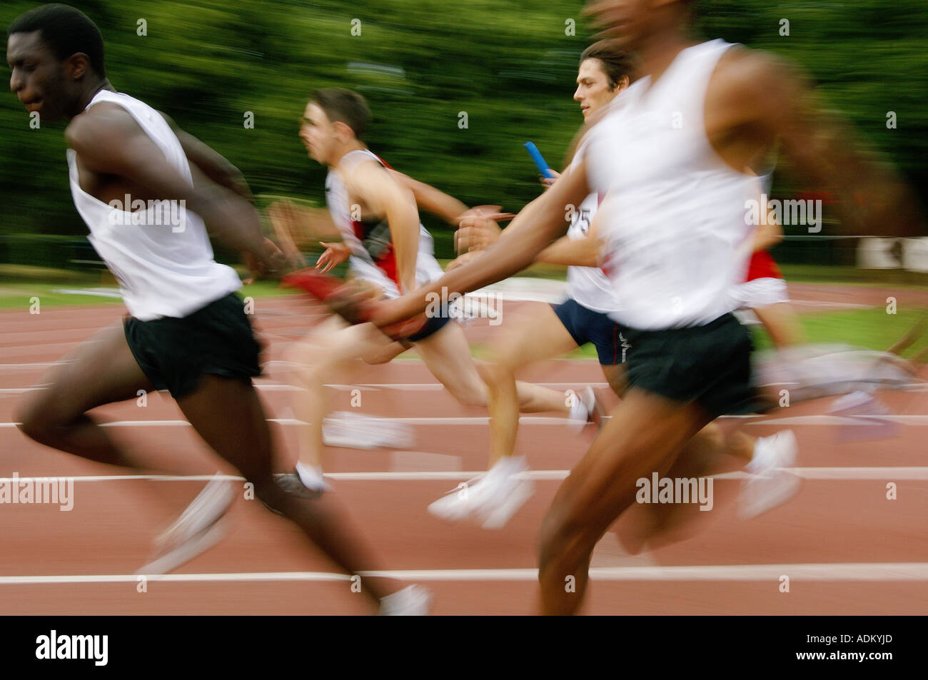 Relay Runners Passing Baton Stock Photo - Alamy
