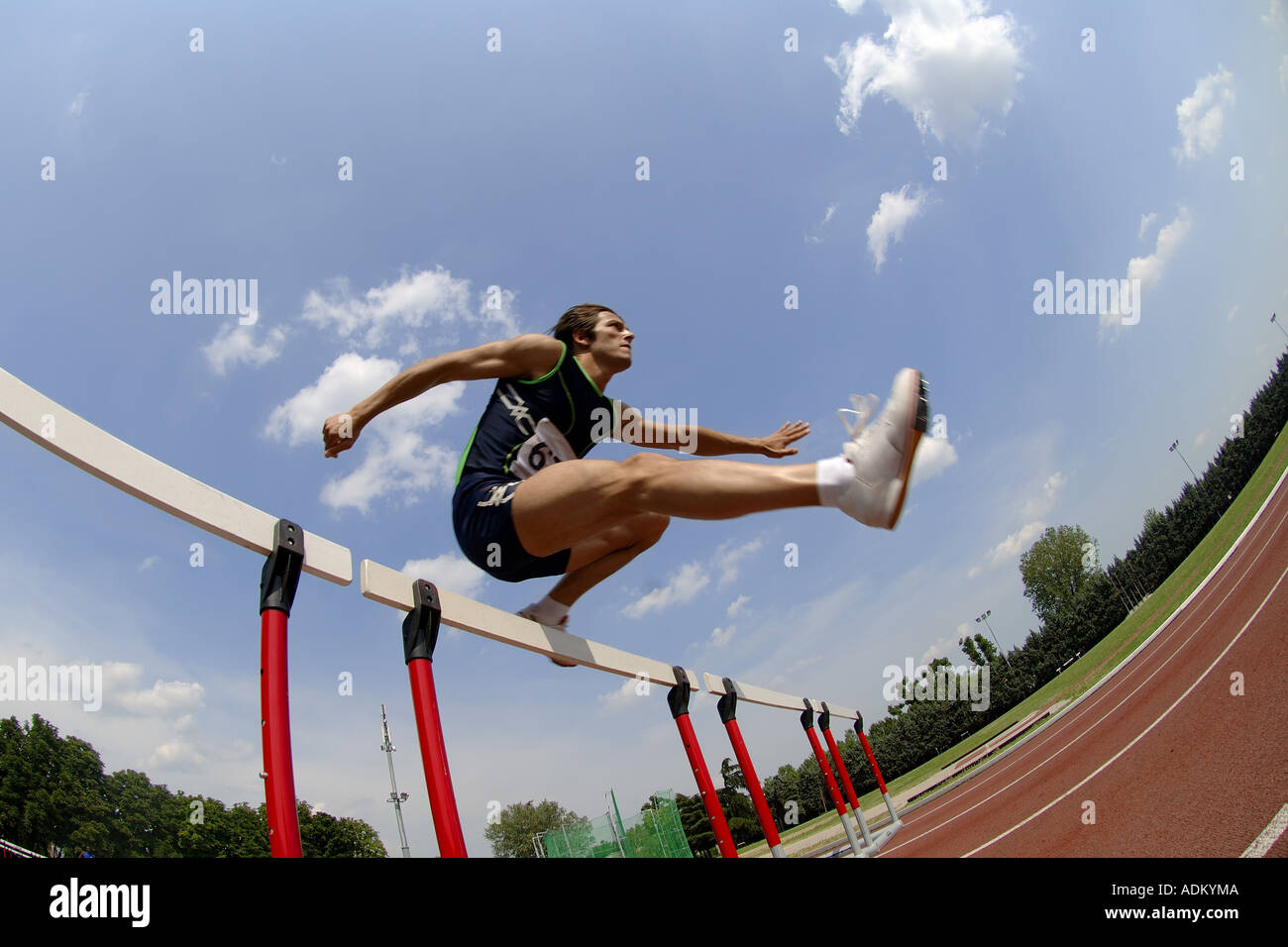Male Runner Clearing a Hurdle Stock Photo - Alamy
