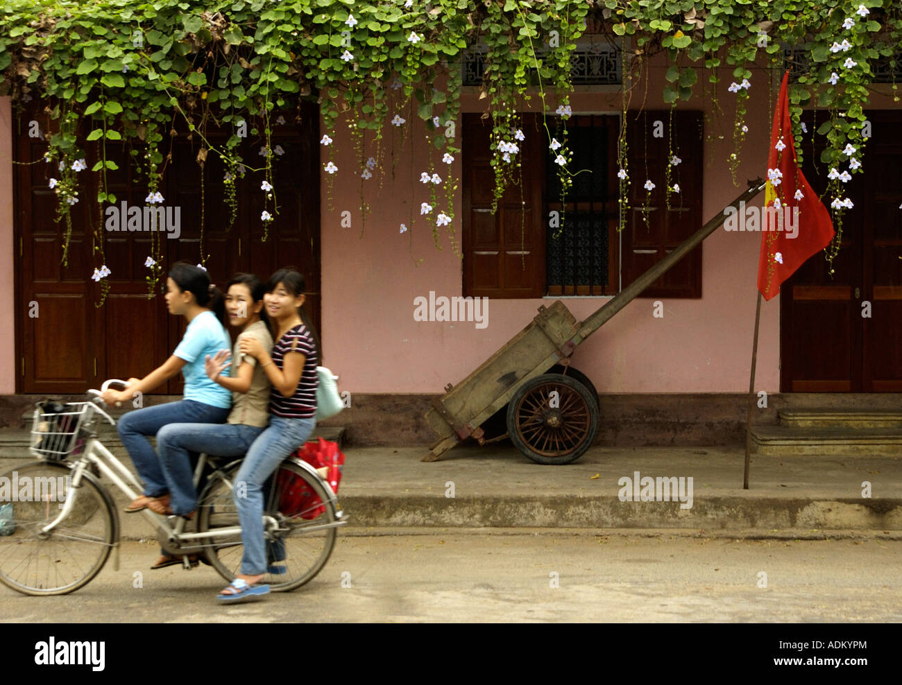 Young teeneagers ride bikes on the streets of Hoi An Vietnam Stock ...