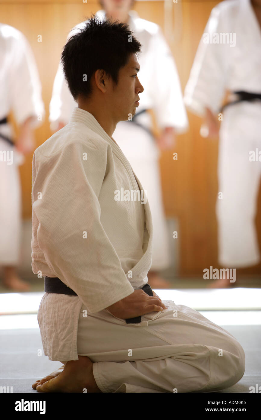 Judo Master Kneeling On a Mat Stock Photo - Alamy