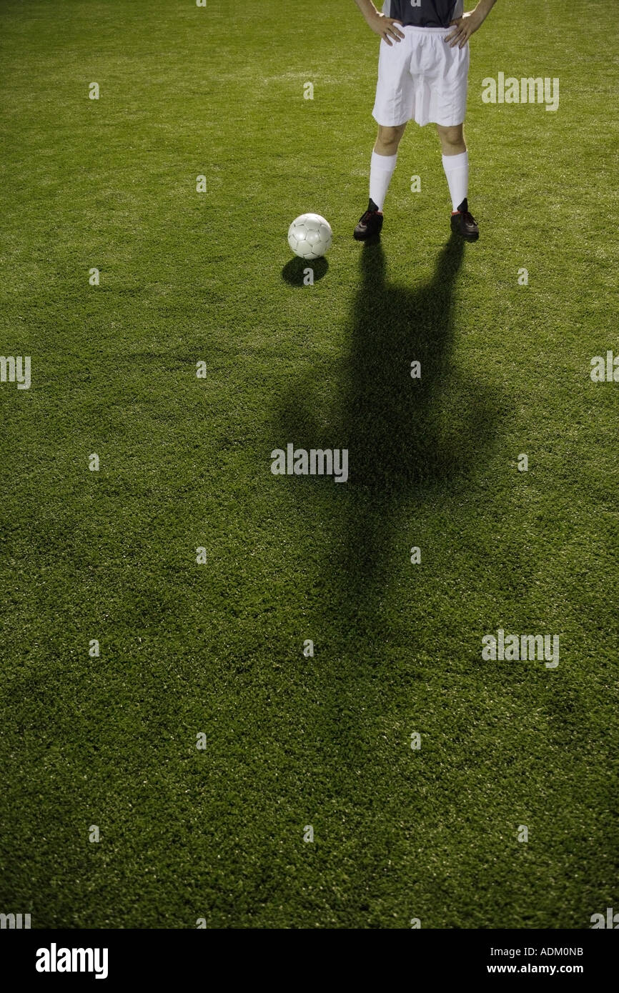 Soccer Player and Ball Standing In Open Field Stock Photo - Alamy