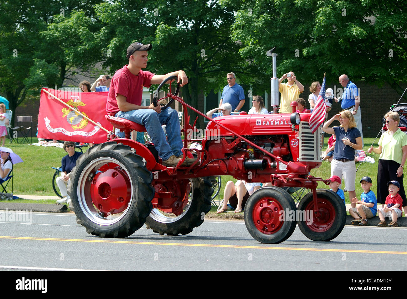 A McCormick Farmall Tractor being driven in a memorial day parade in ...