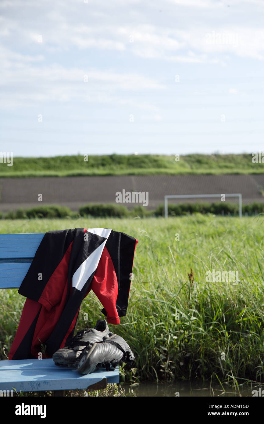 Cleats And A Soccer Jersey Lying On a Bench Stock Photo - Alamy