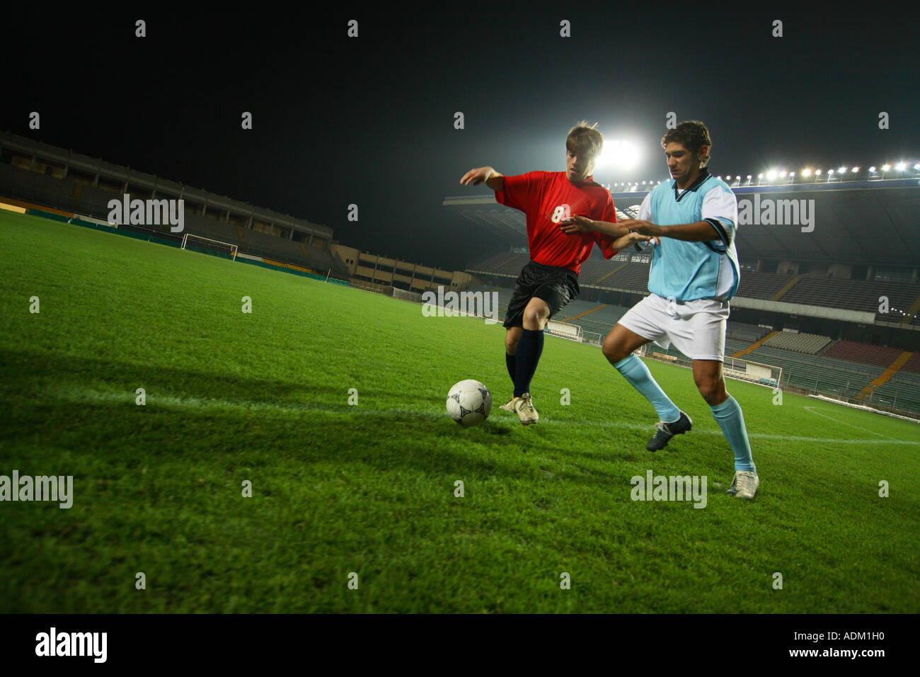 Two Soccer Players Chasing A Ball Stock Photo - Alamy