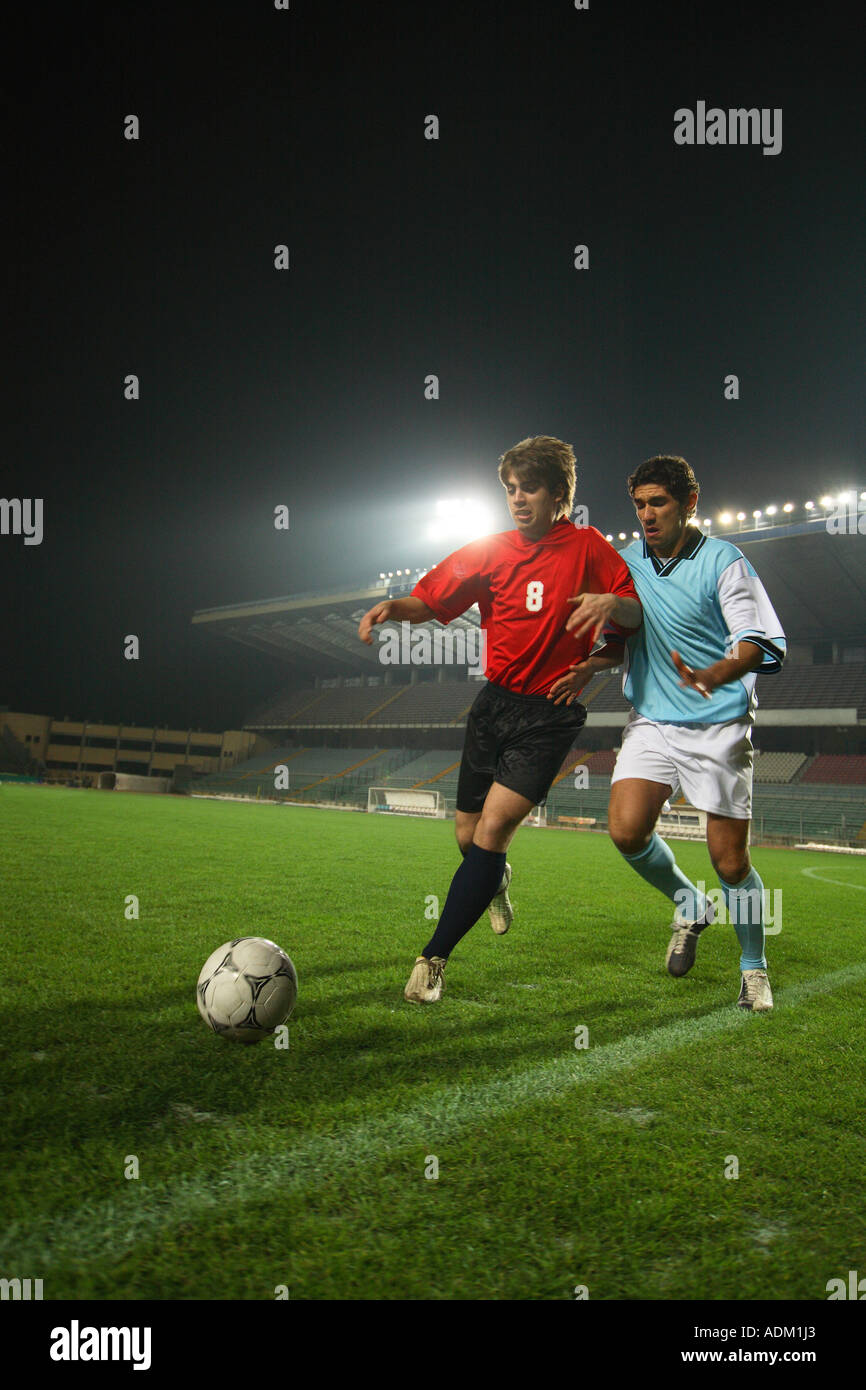 Two Soccer Players Chasing A Ball Stock Photo - Alamy