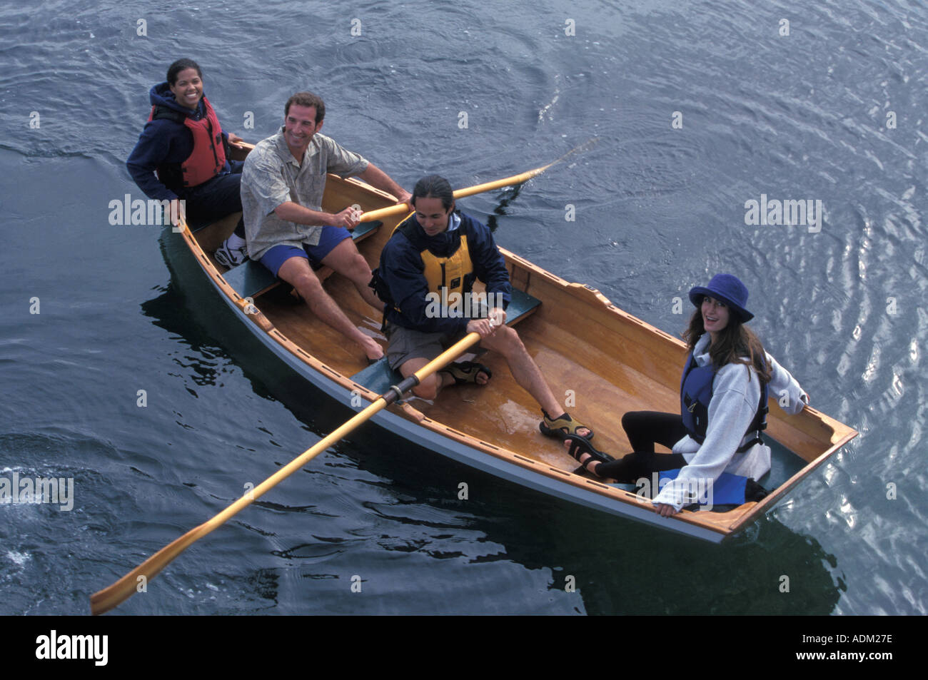 Group Of Friends Smiling From A Canoe Stock Photo - Alamy