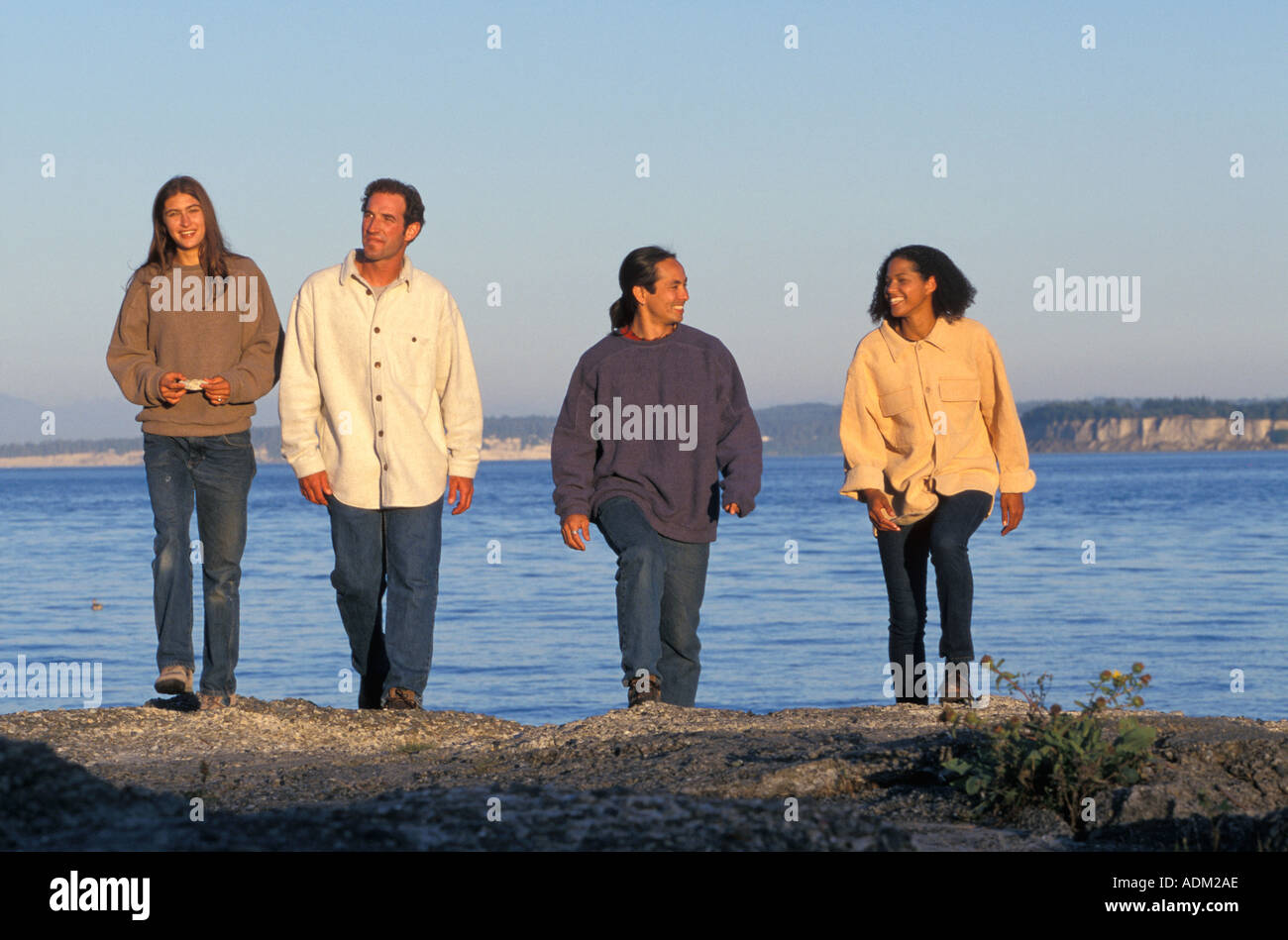 Group Of Friends Hiking Along The Lake Shore Stock Photo - Alamy