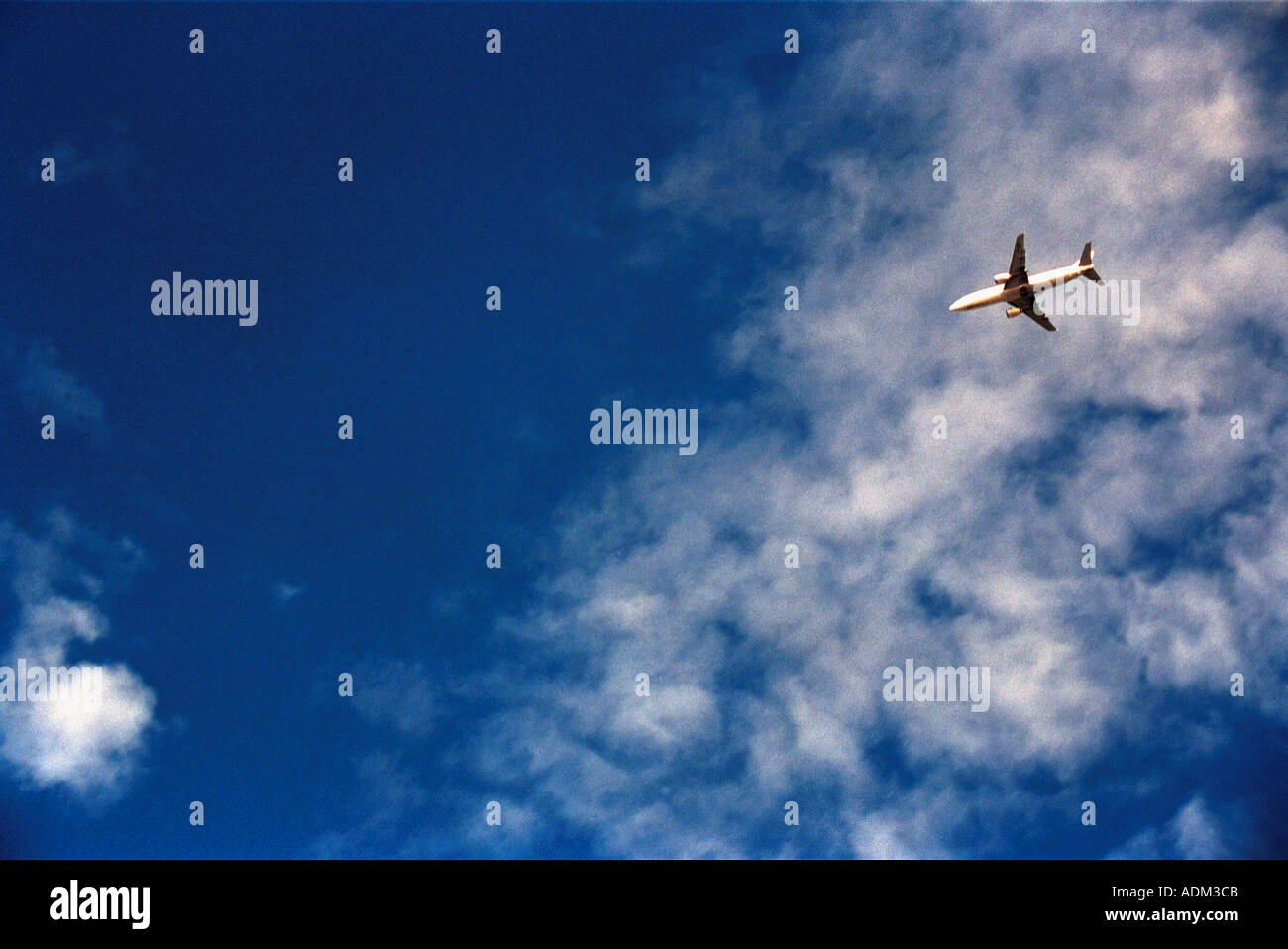 plane moving across sky with clouds Stock Photo - Alamy