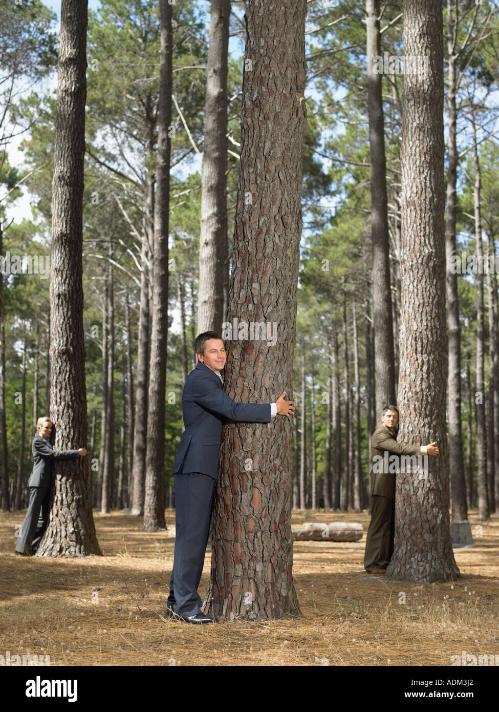 Office workers hugging trees Stock Photo - Alamy
