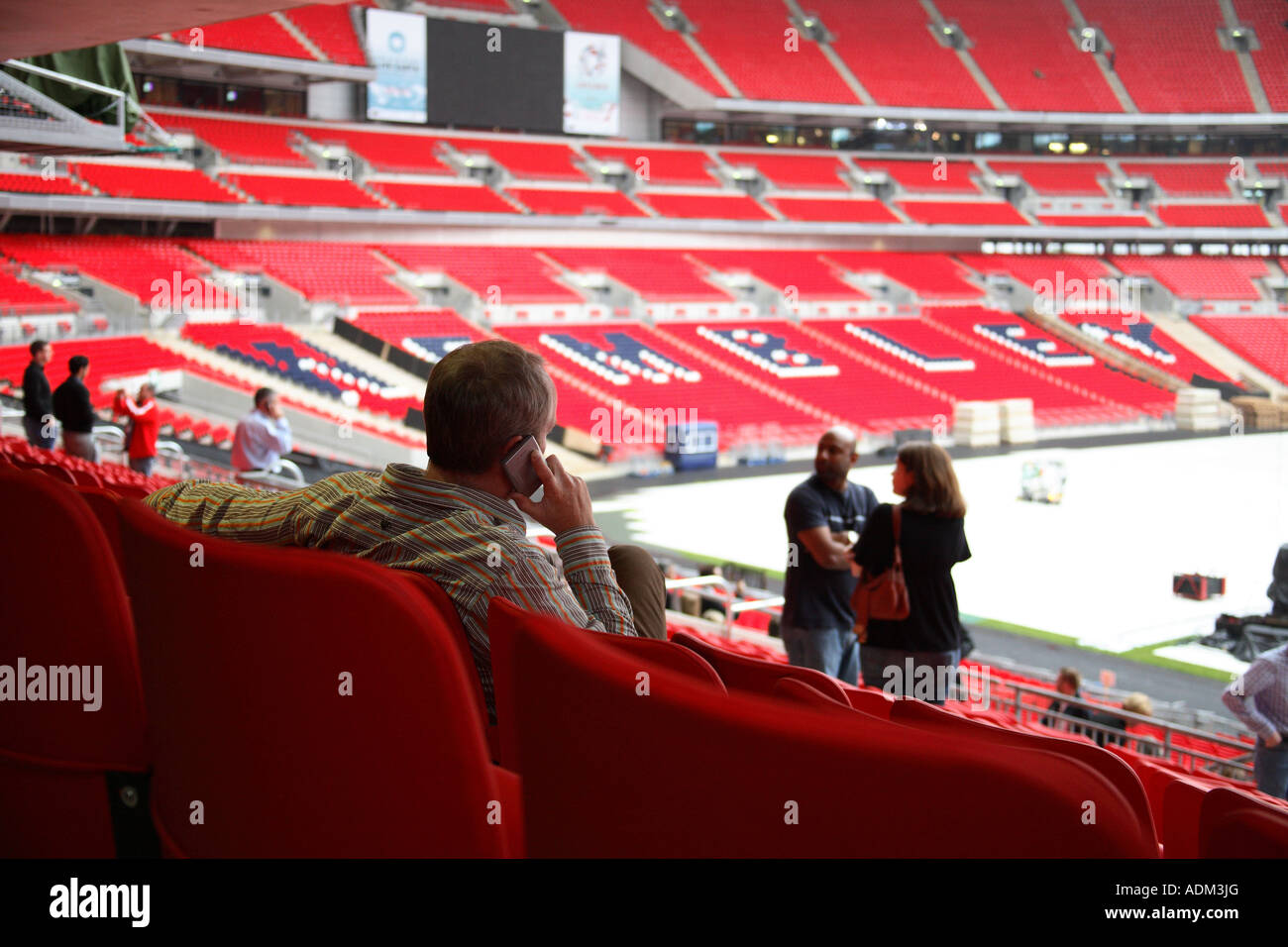 Man on cellphone seated in Wembley Stadium Stock Photo - Alamy