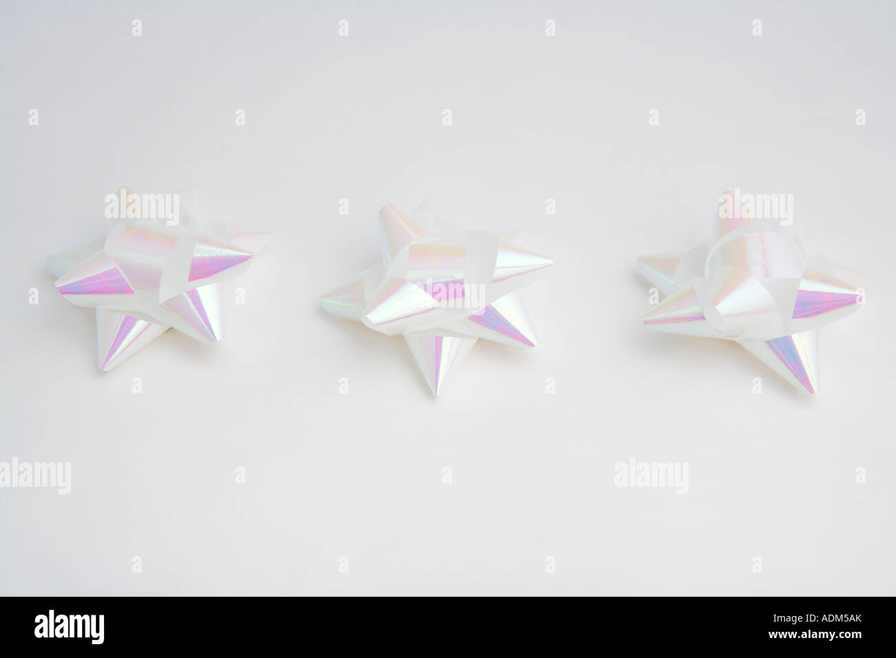 Three white Christmas gift bows in row on white background studio ...