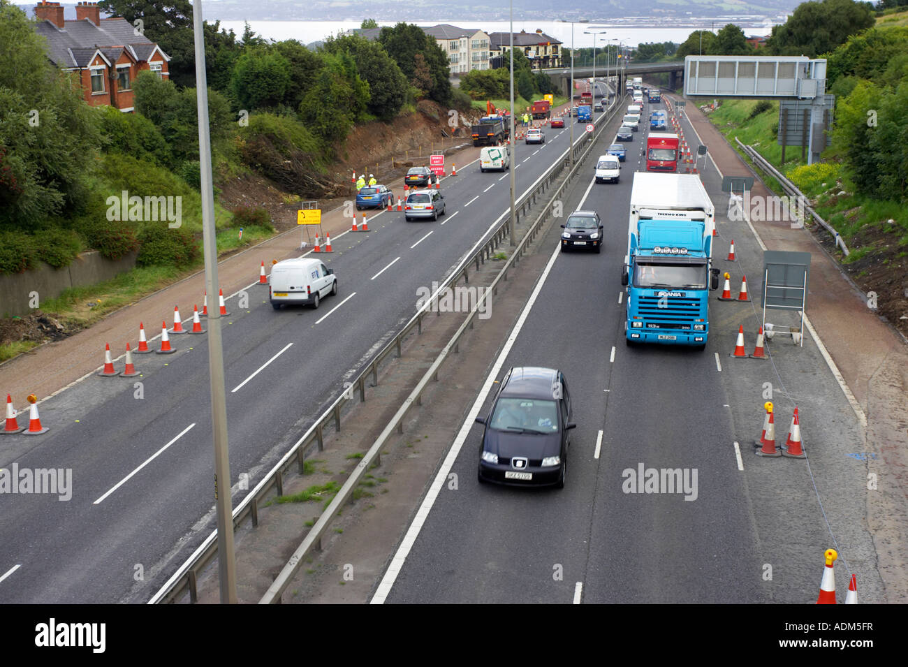 Traffic on the motorway with traffic cones and construction work on ...