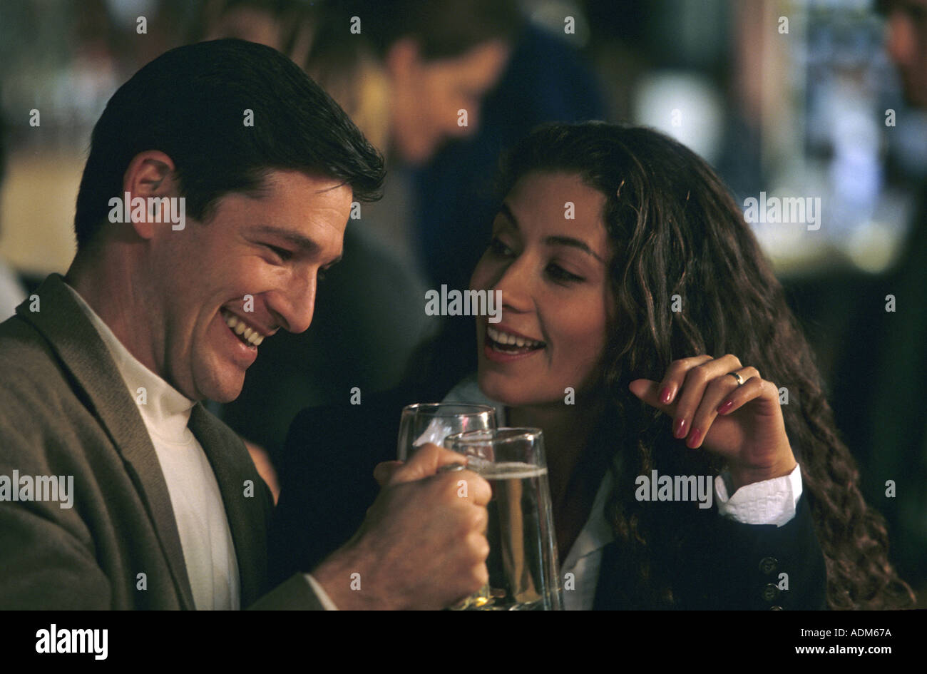 couple at a bar having beers Stock Photo - Alamy