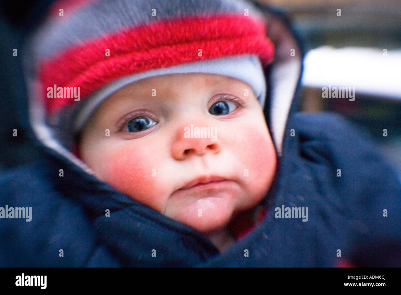 Closeup portrait with selective focus of infant girl with rosy cheeks ...
