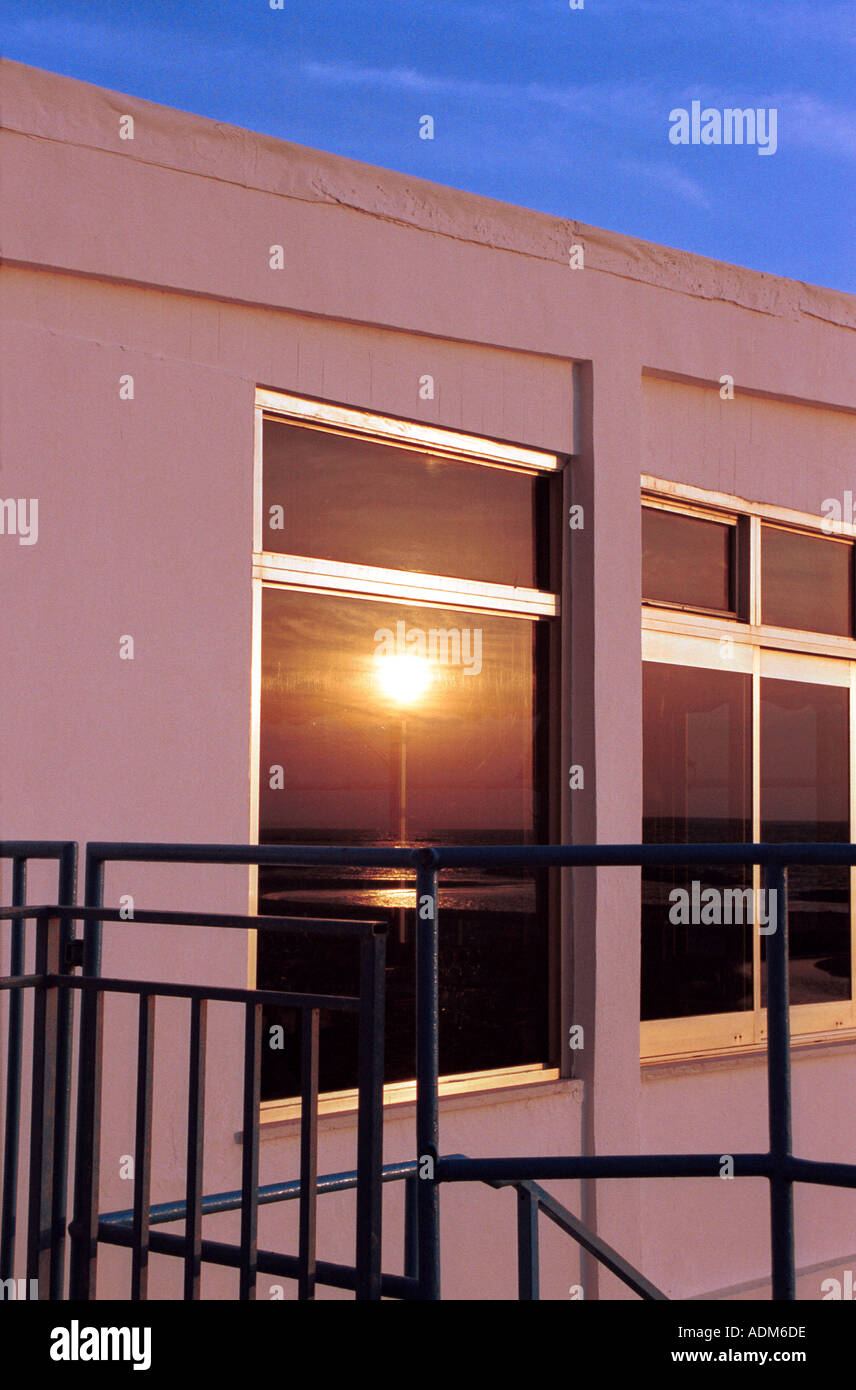 sunset reflected in beach building window Stock Photo - Alamy
