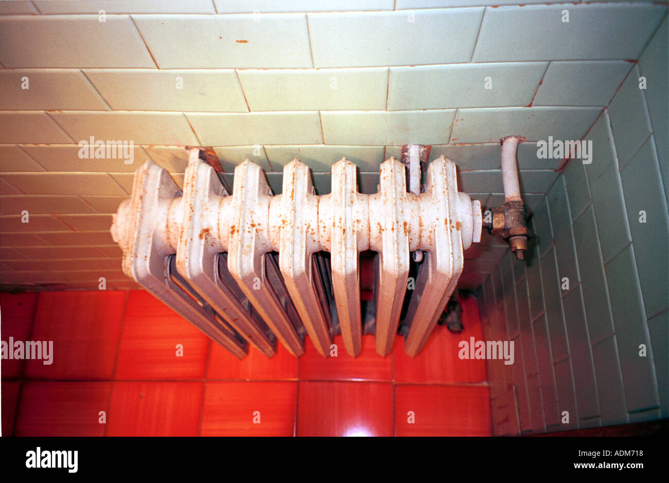 old fashioned radiator and tiled wall and floor Stock Photo - Alamy
