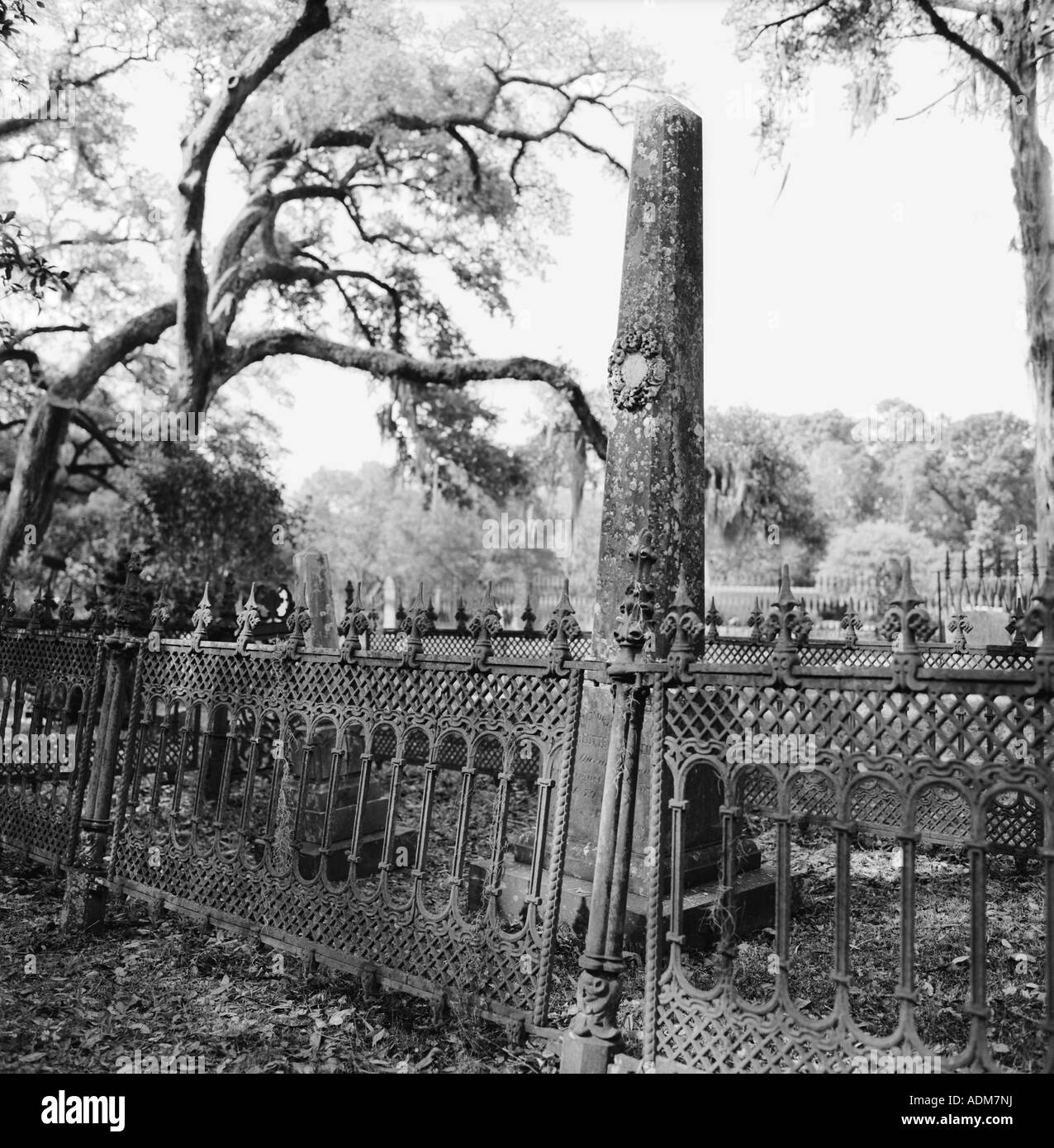 Very old obelisk grave marker with ornate cast iron fence in St ...