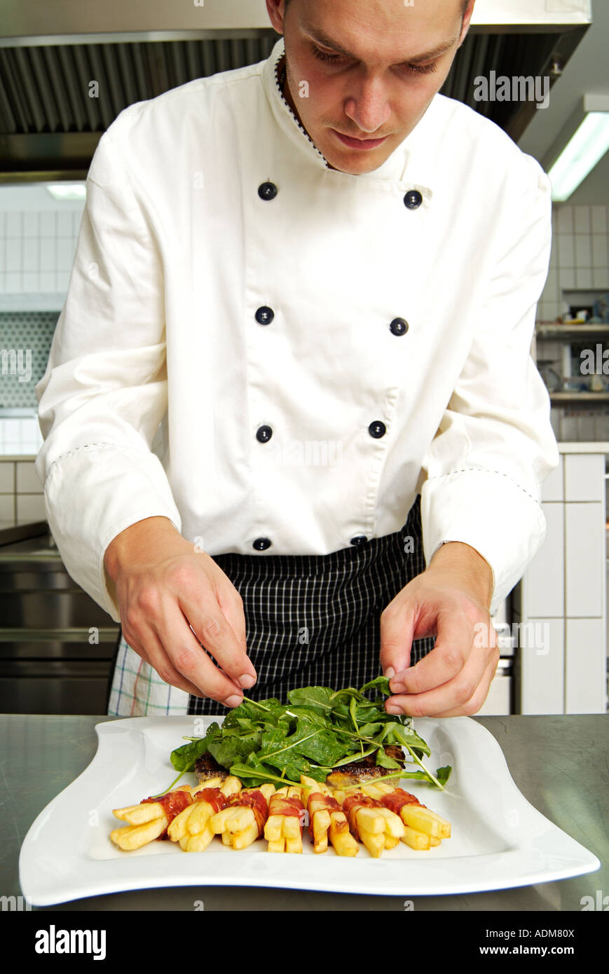 Chef Preparing a Meal of Stake and Chips Garnished with Spinach Stock ...