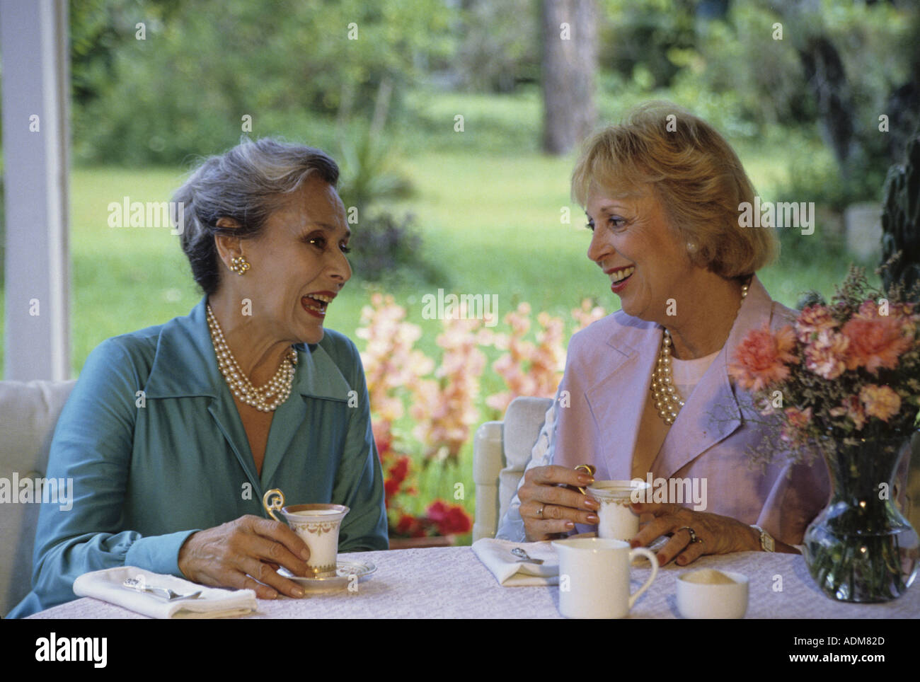 Two mature senior women having coffee together Stock Photo - Alamy
