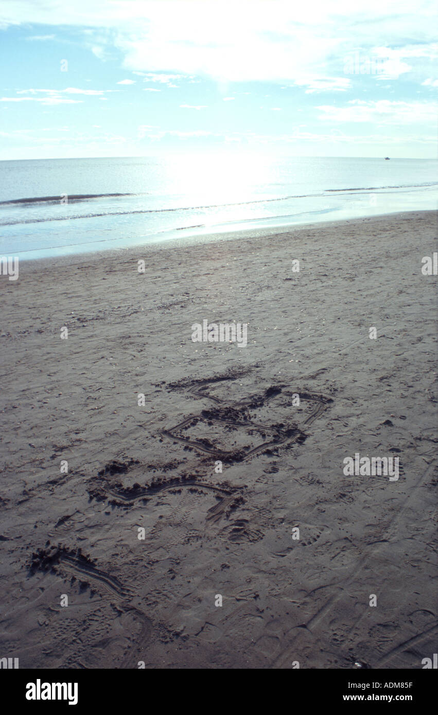 sos written on sand on beach Stock Photo - Alamy