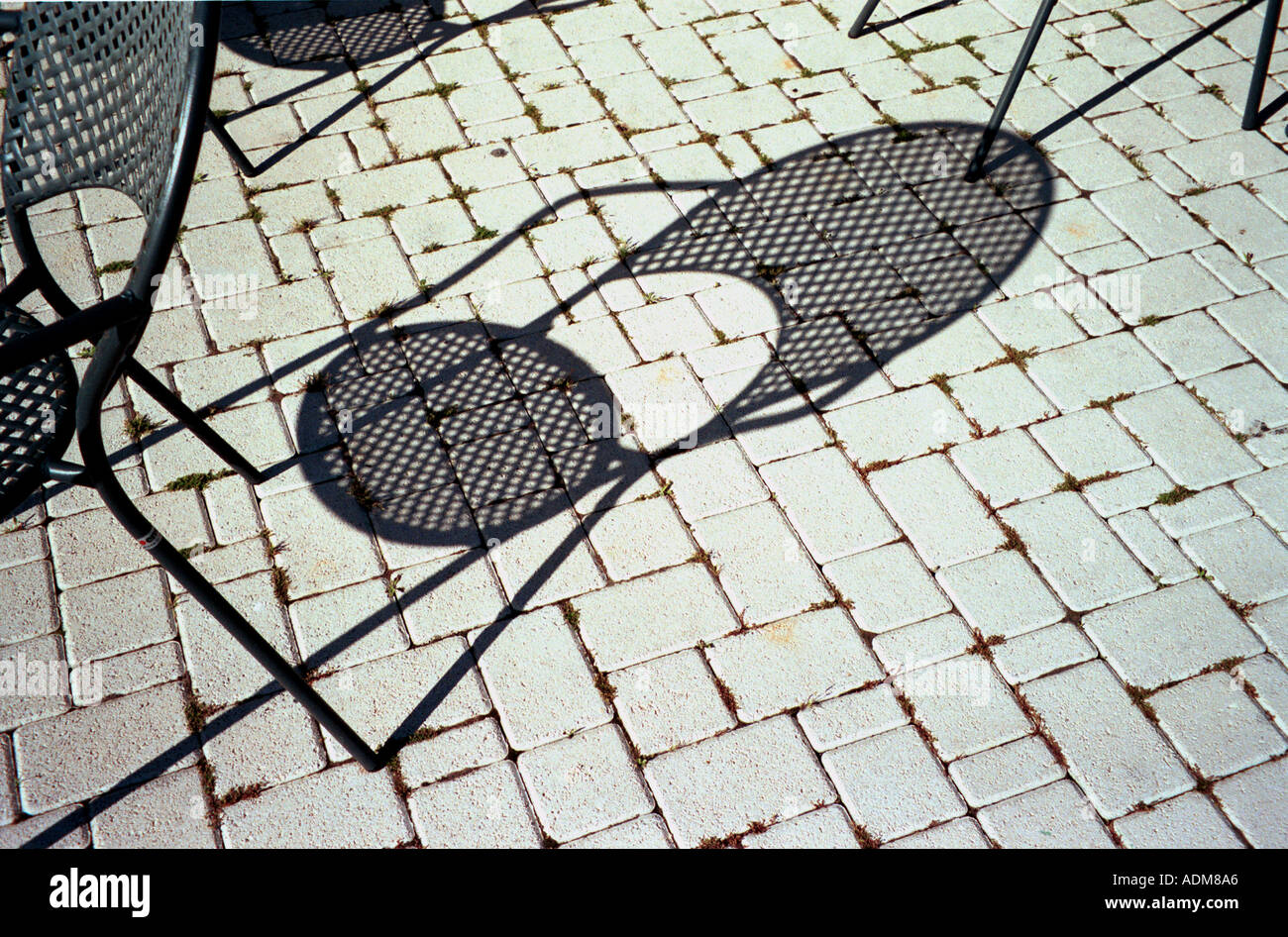 metal chair shadow on tiled floor outside Stock Photo - Alamy