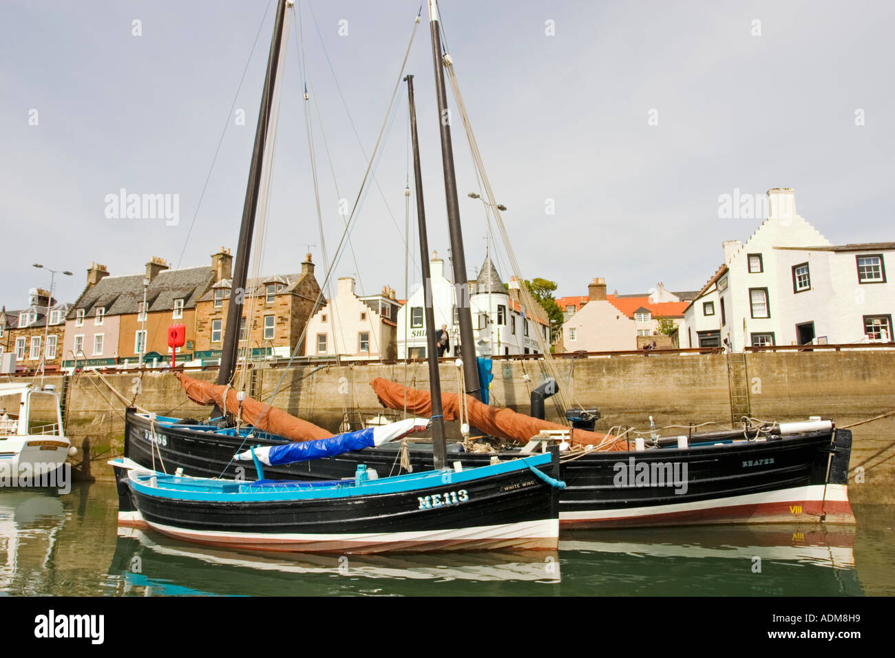 Traditional tall masted fishing boats in Anstruther Harbour harbor ...