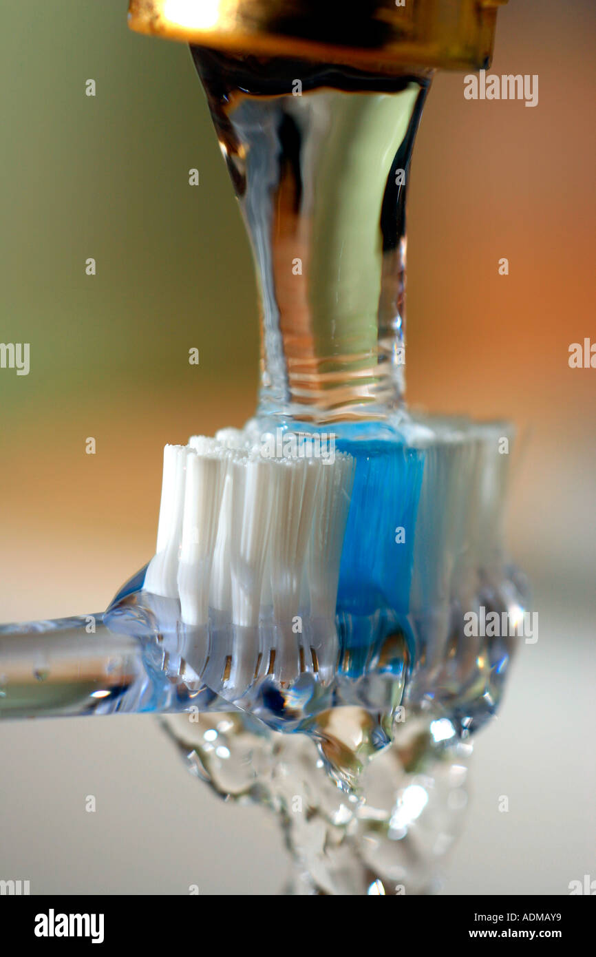 Toothbrush under running water hi-res stock photography and images - Alamy