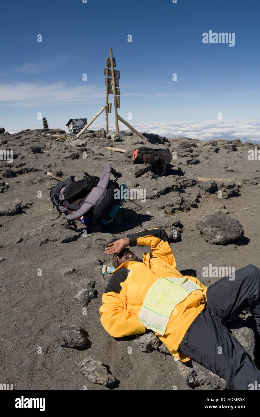 Africa Tanzania Kilimanjaro National Park MR Exhausted climber lies ...