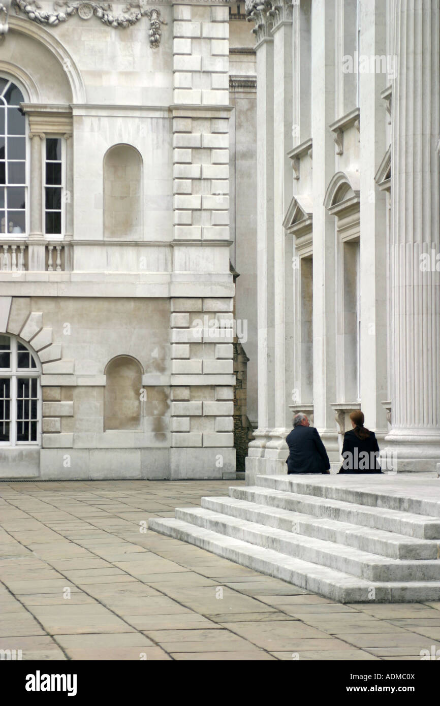 Two people sitting outside Senate House Cambridge Stock Photo - Alamy