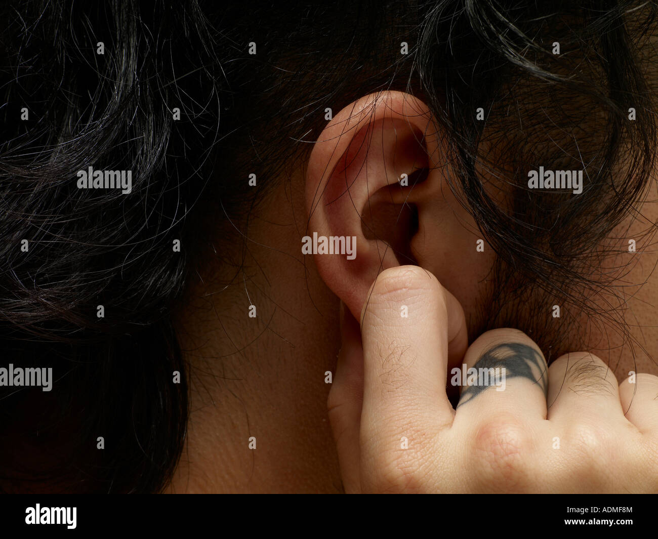 Man pulling his ear close up Stock Photo - Alamy