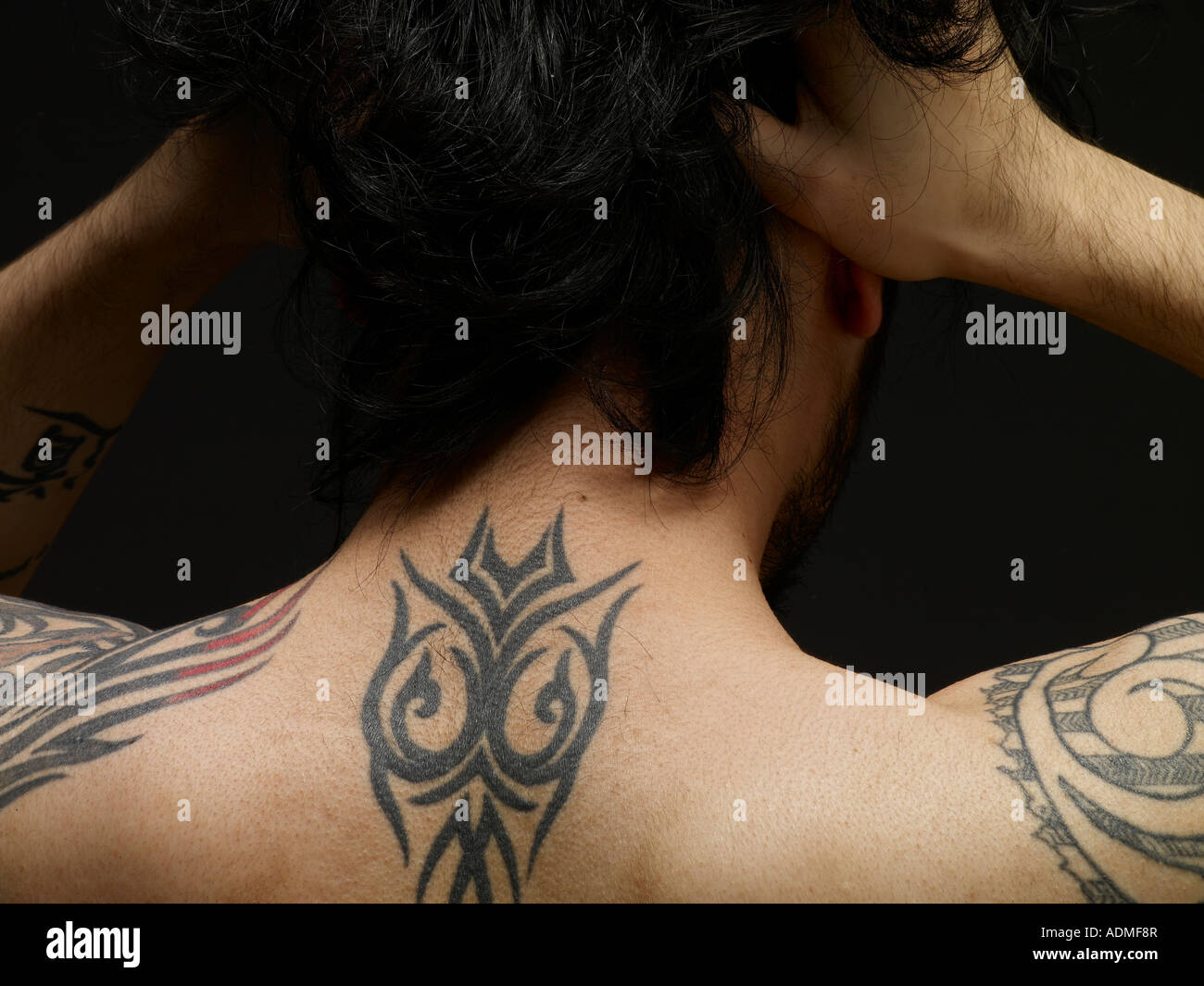 Bare chested man pulling his hair back view Stock Photo - Alamy