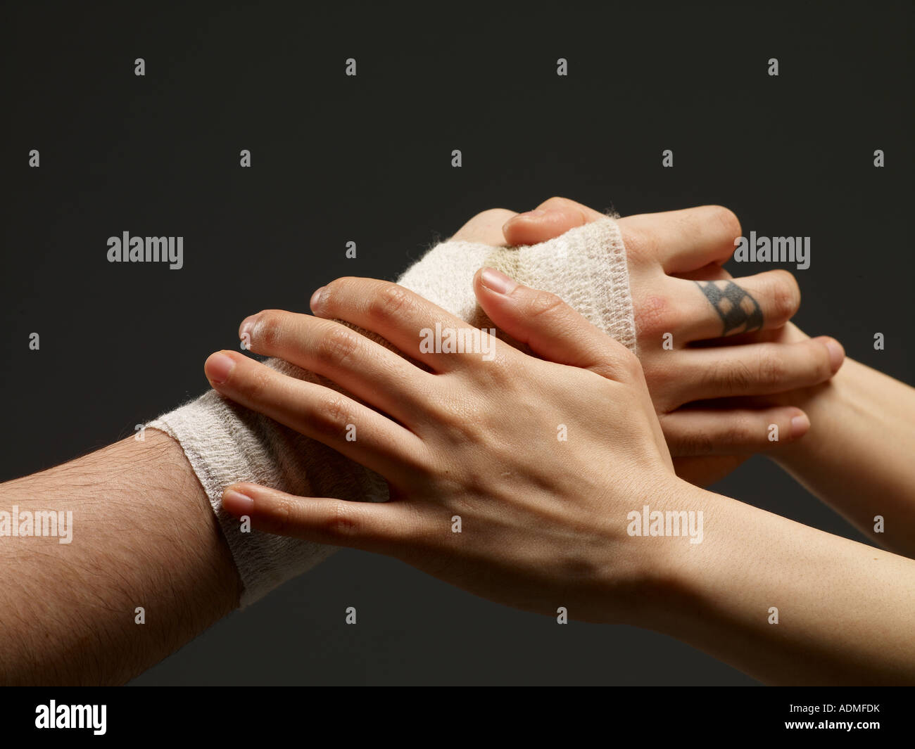 Pair of hands holding another bandaged hand close up Stock Photo - Alamy