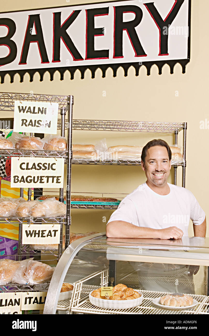 Man smiling at camera in bakery, portrait Stock Photo - Alamy
