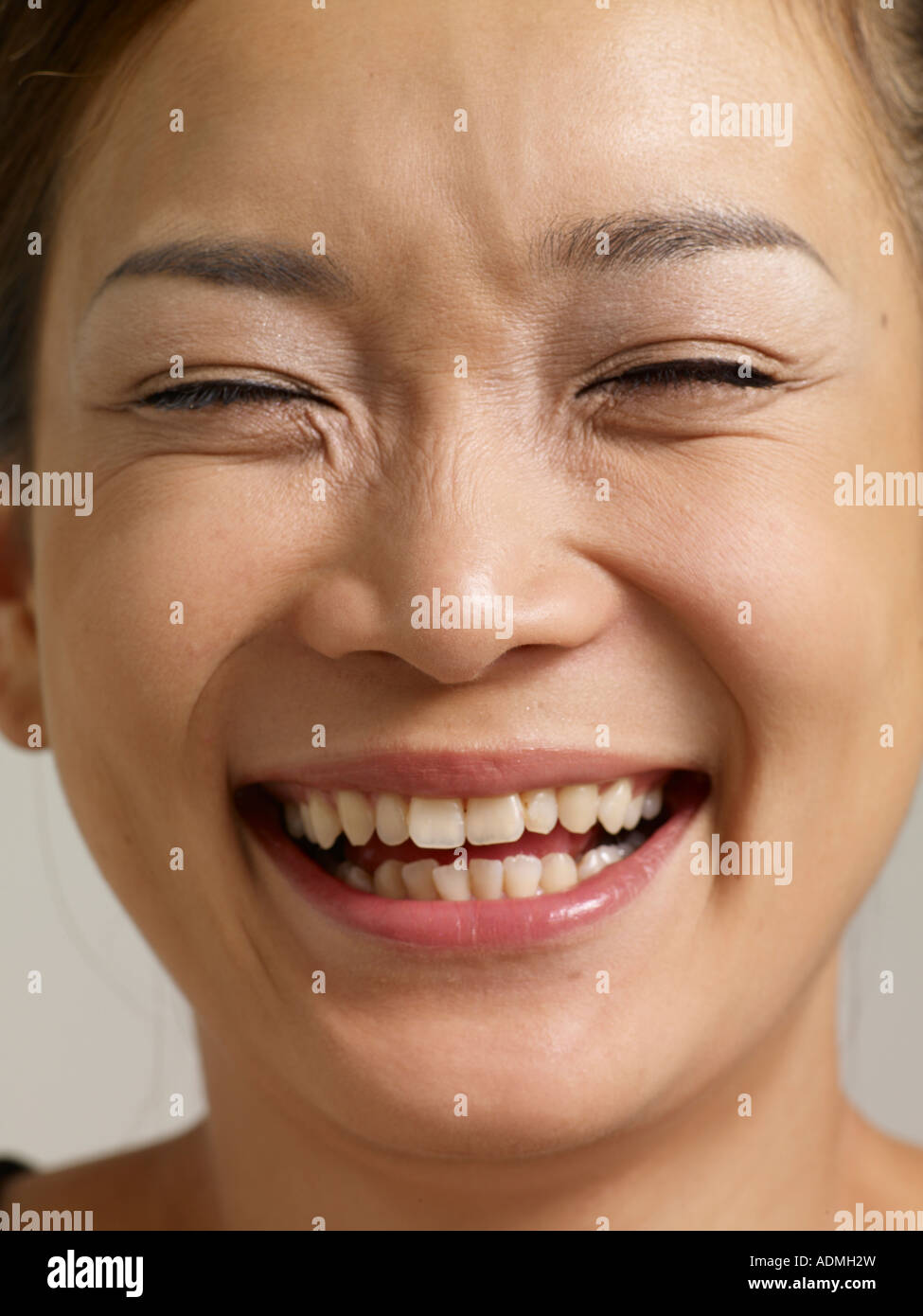 Young woman smiling with eyes closed Stock Photo - Alamy