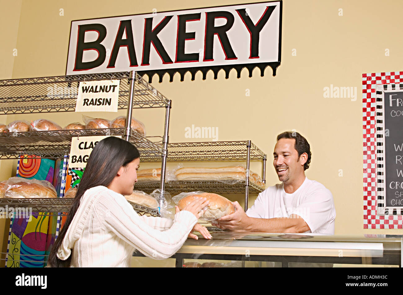 Woman buying fresh bread in bakery Stock Photo - Alamy