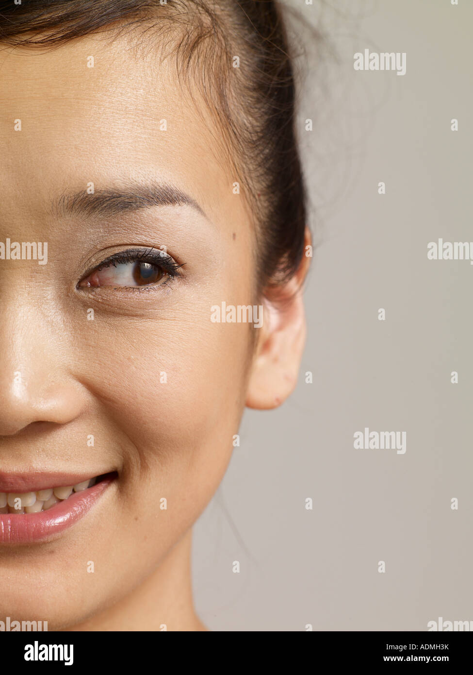 Young woman glancing sideways smiling Stock Photo - Alamy