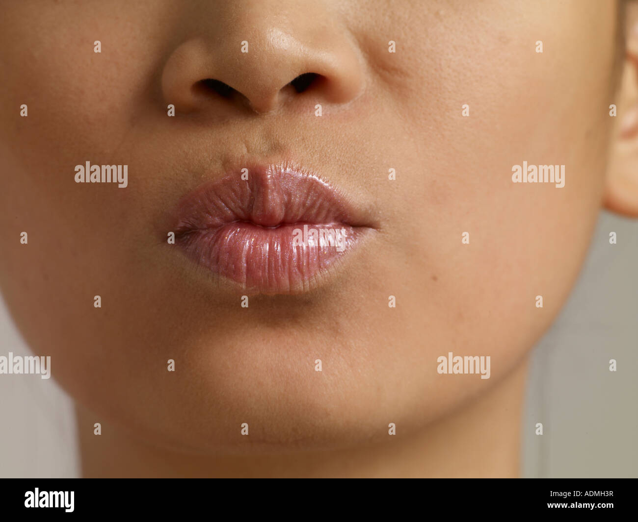 Young woman puckering lips close up Stock Photo - Alamy