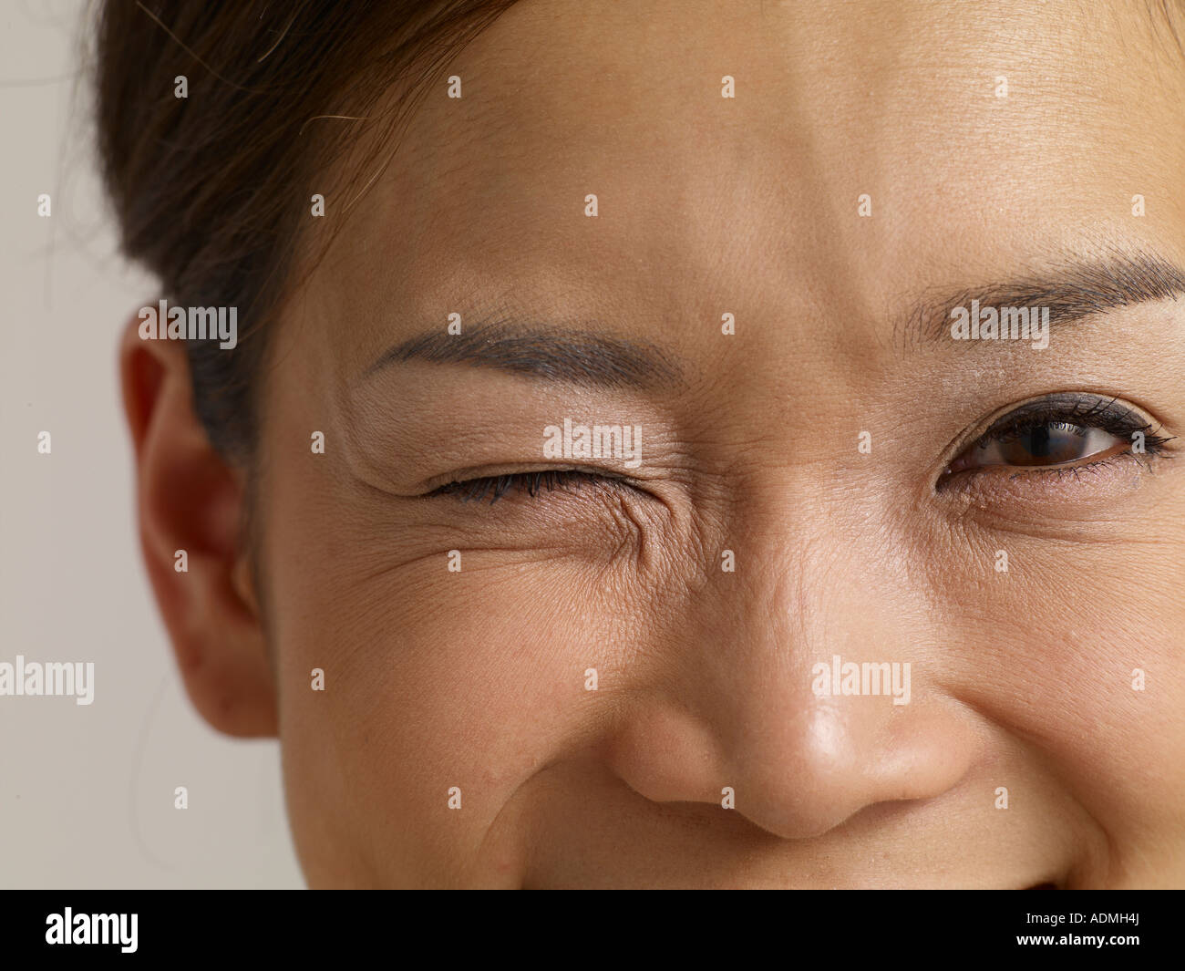 Close up of a woman winking Stock Photo - Alamy