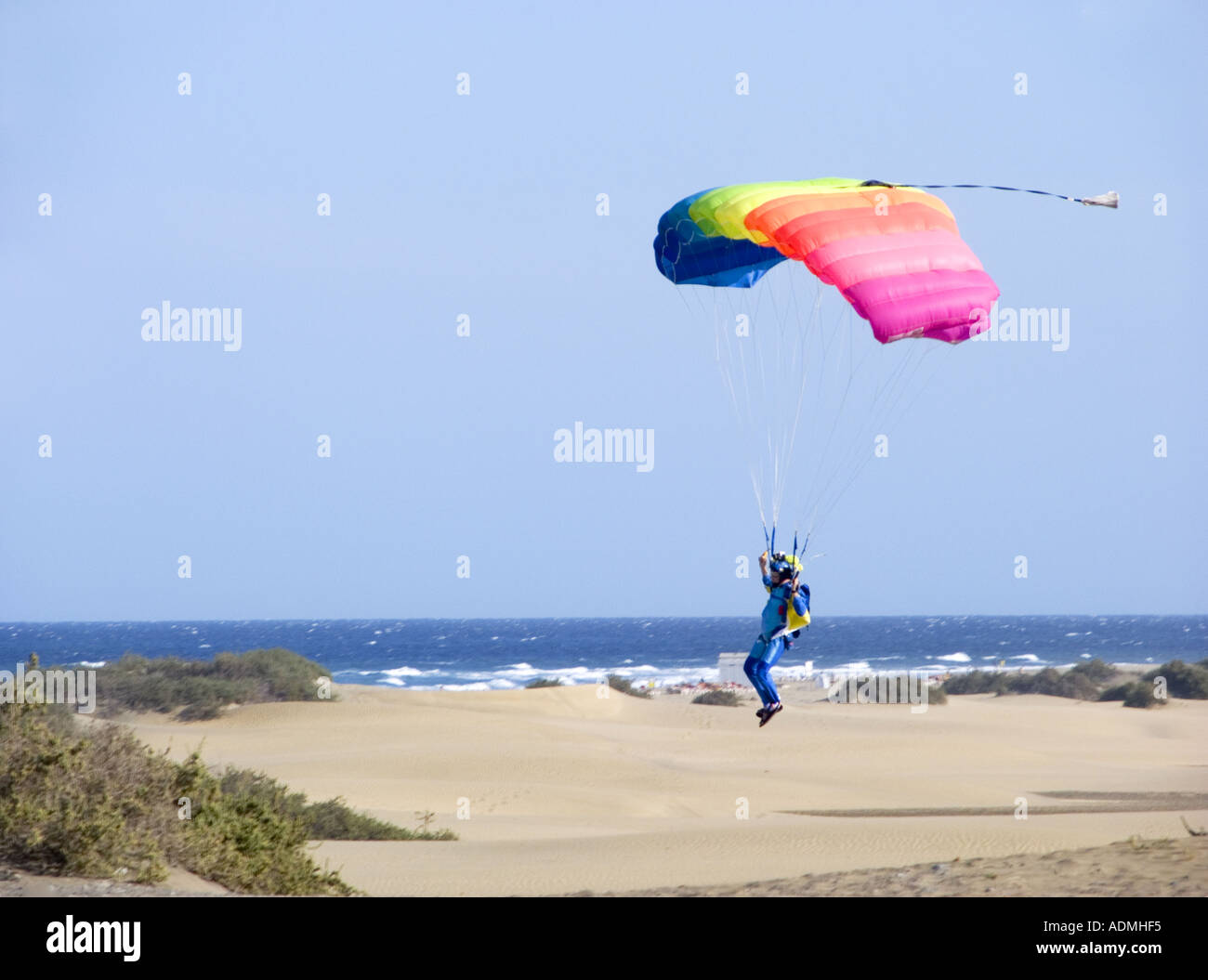 paraglider parachutist skydiver hang glider sea ocean dune dunes sand ...