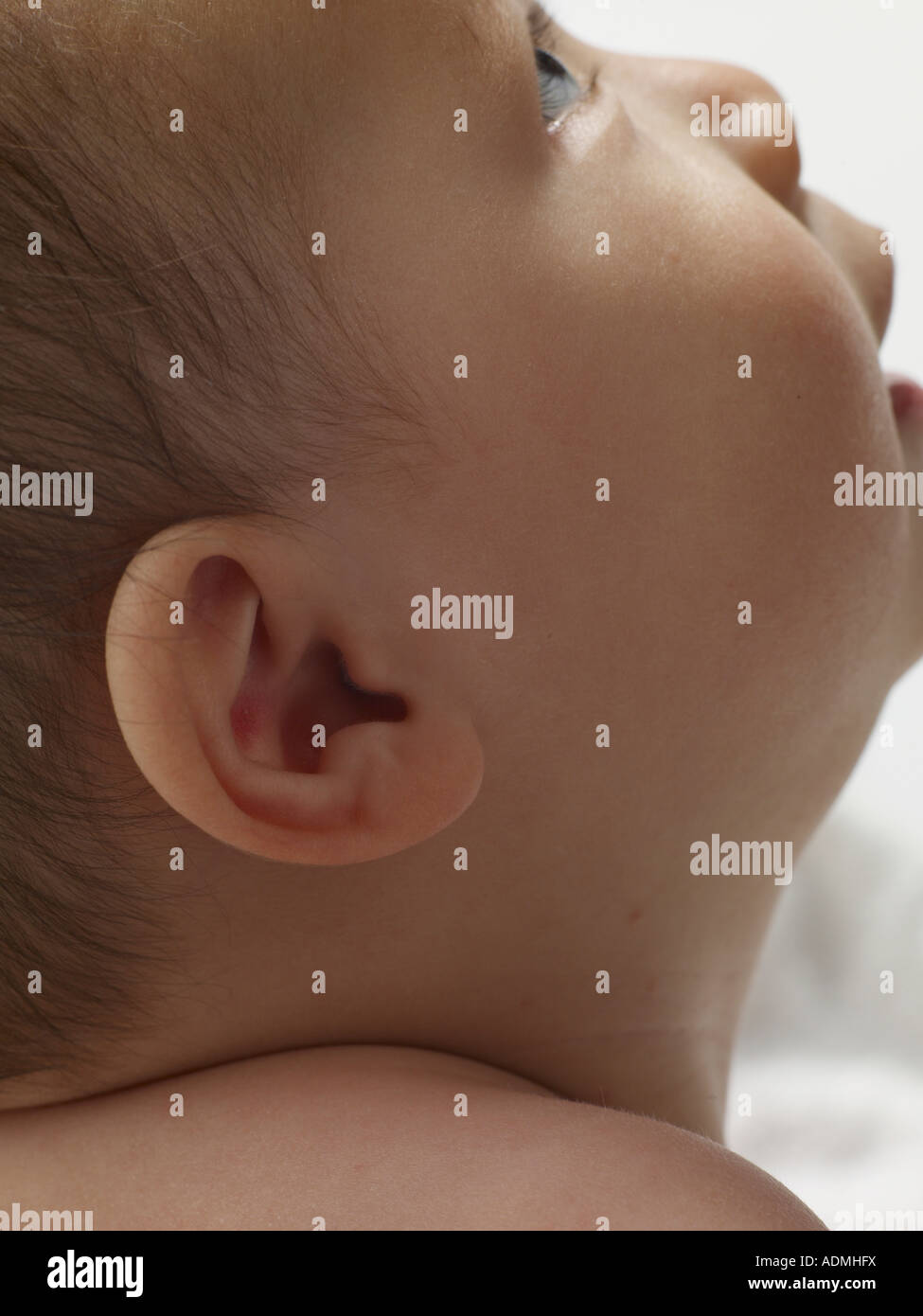 Close up of baby looking up side view Stock Photo - Alamy