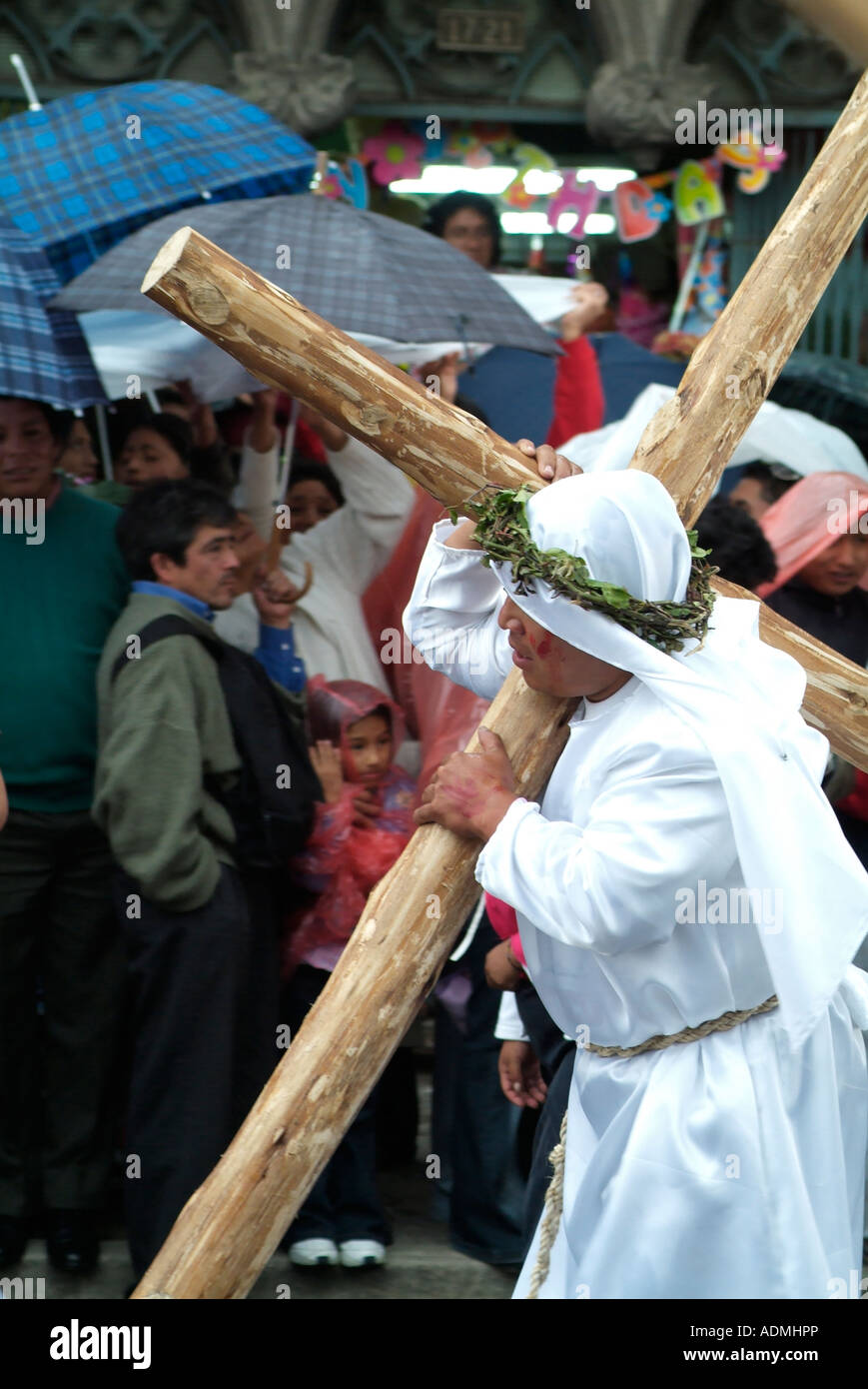 Penitent carrying a heavy cross in the Easter procession in Quito ...