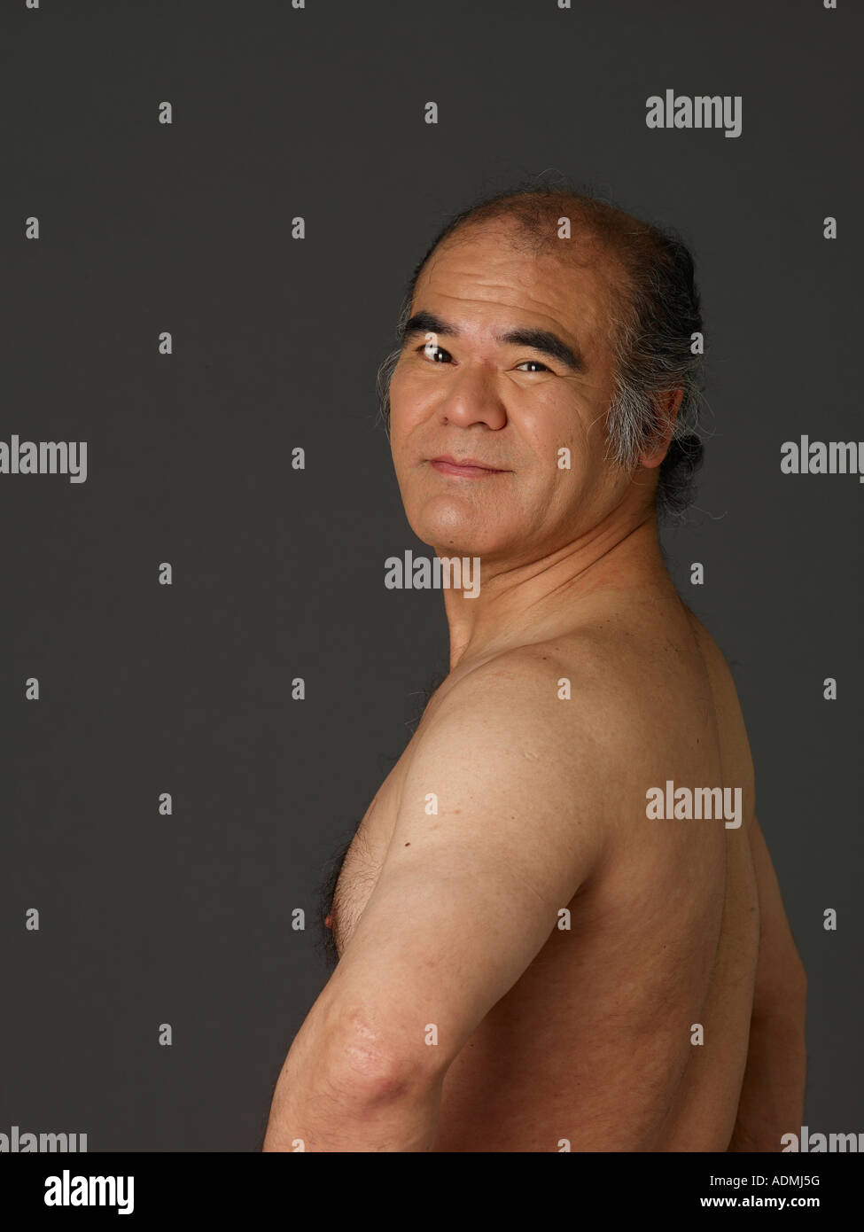 Portrait of a shirtless man turning back to face the camera Stock Photo ...