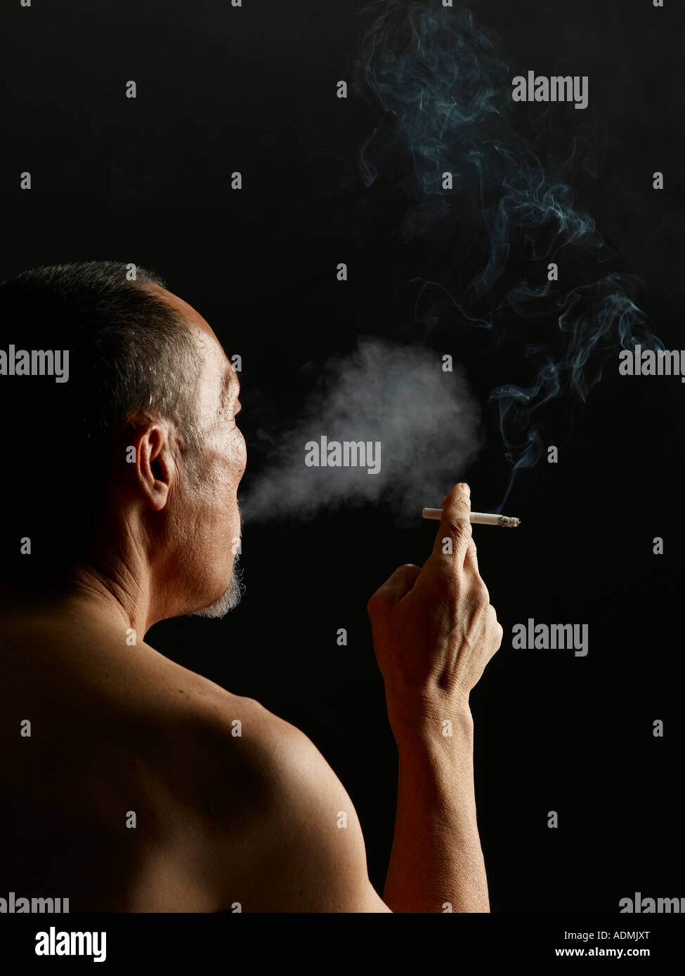 Mature man holding a cigarette and smoking back view Stock Photo - Alamy