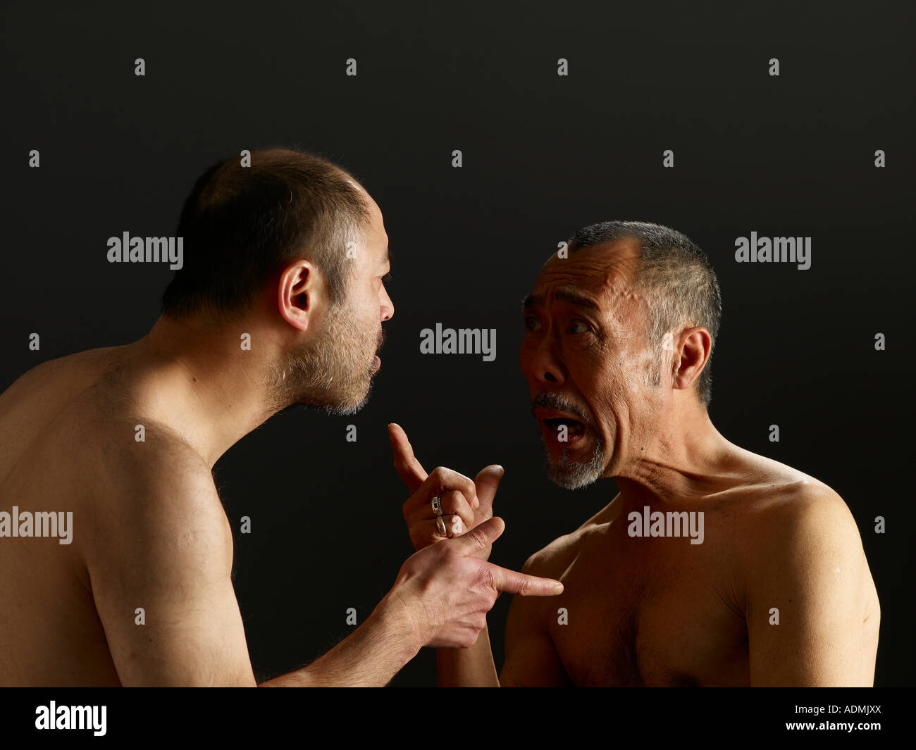 Two shirtless mature men arguing Stock Photo - Alamy